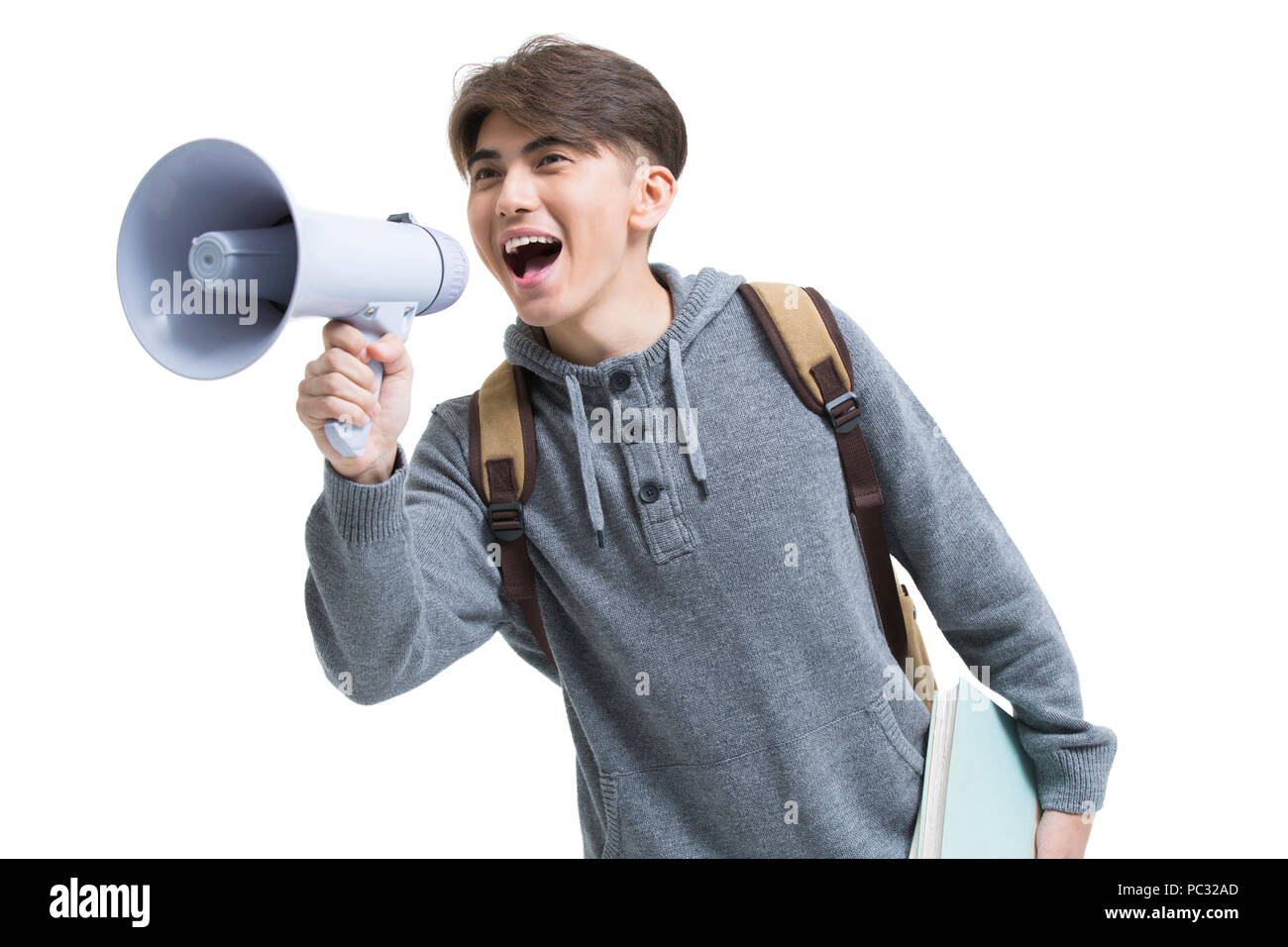 Cheerful male college student shouting through megaphone Stock Photo ...