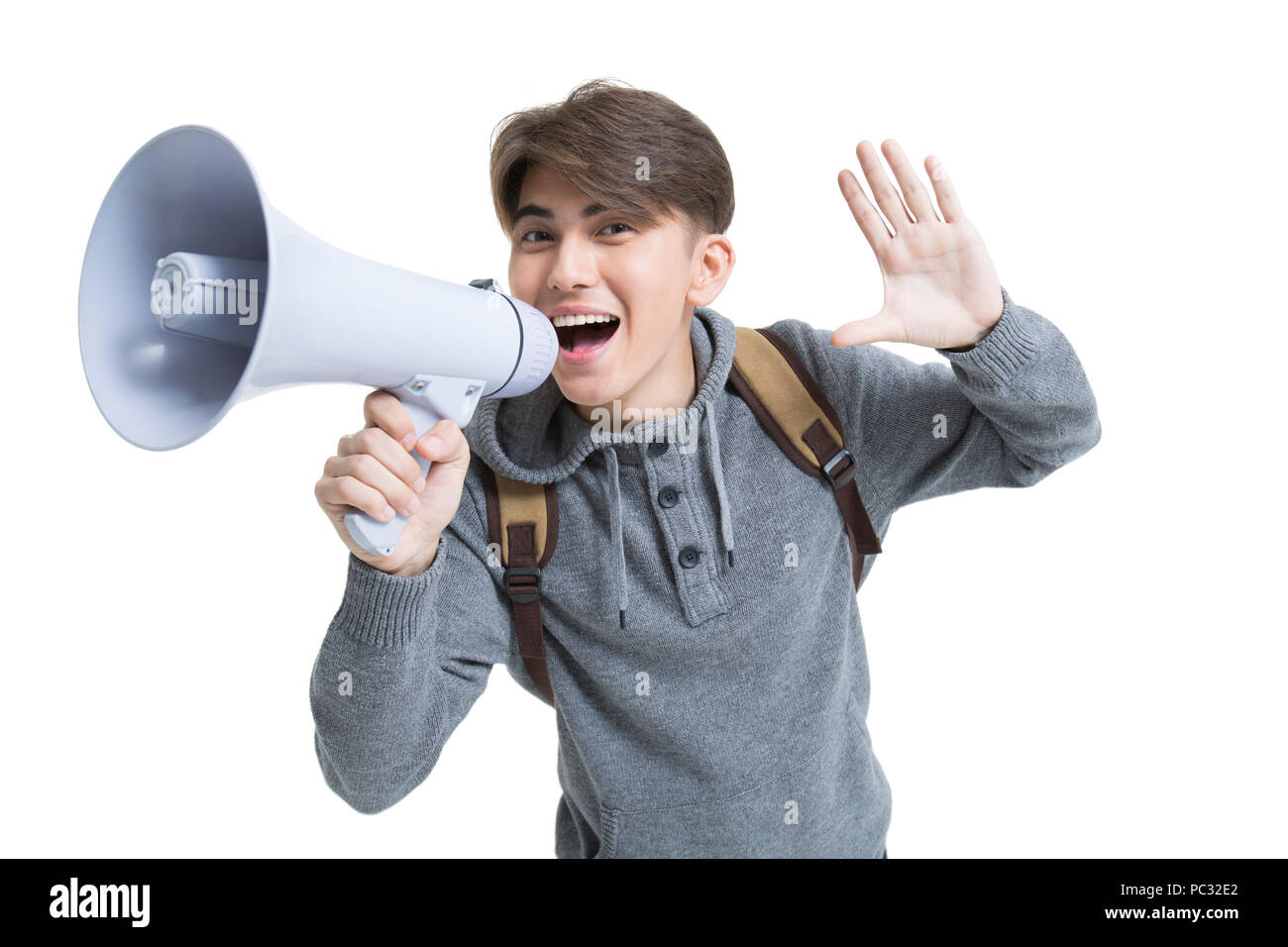 Cheerful male college student shouting through megaphone Stock Photo ...