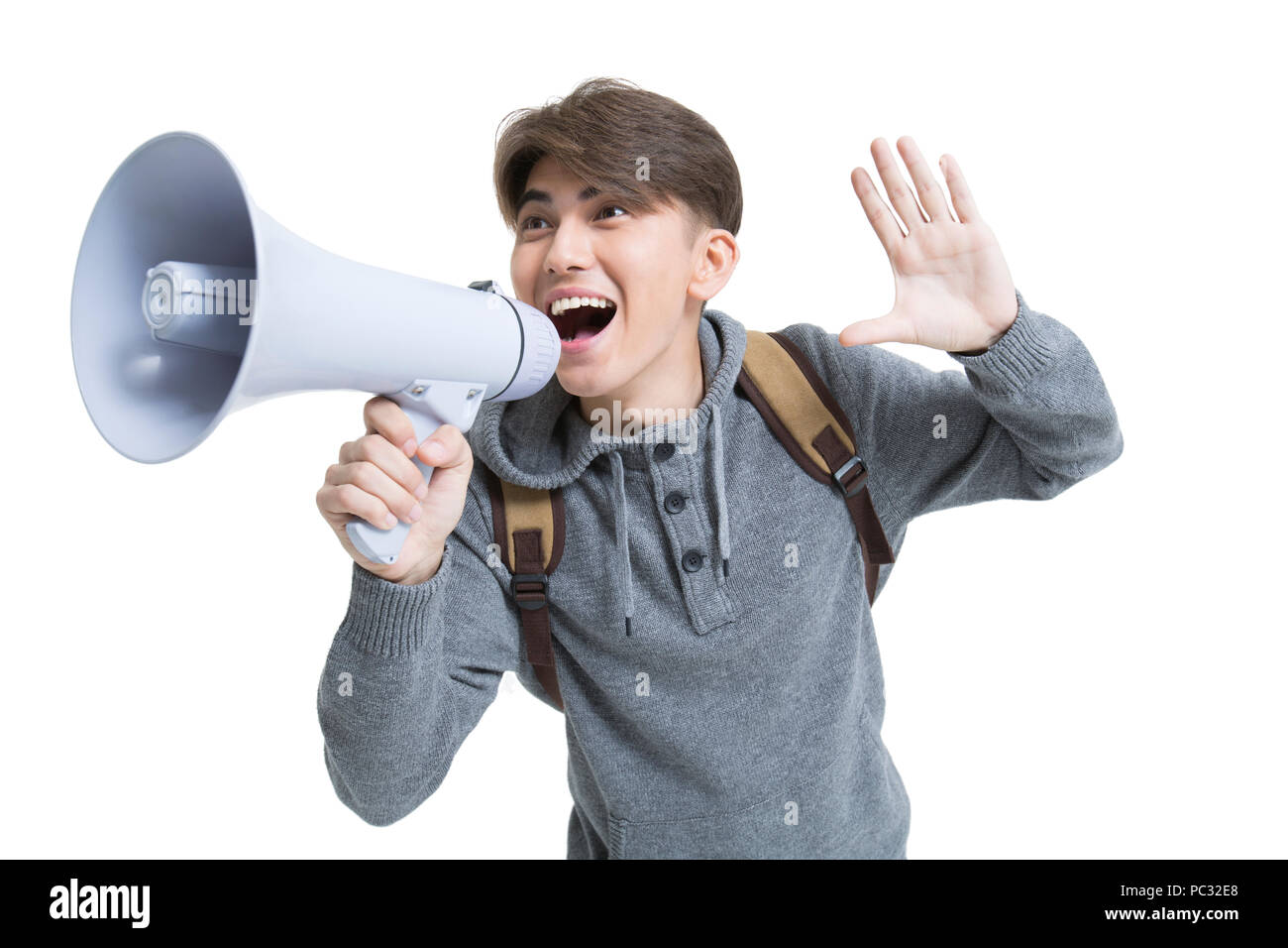 Cheerful male college student shouting through megaphone Stock Photo ...
