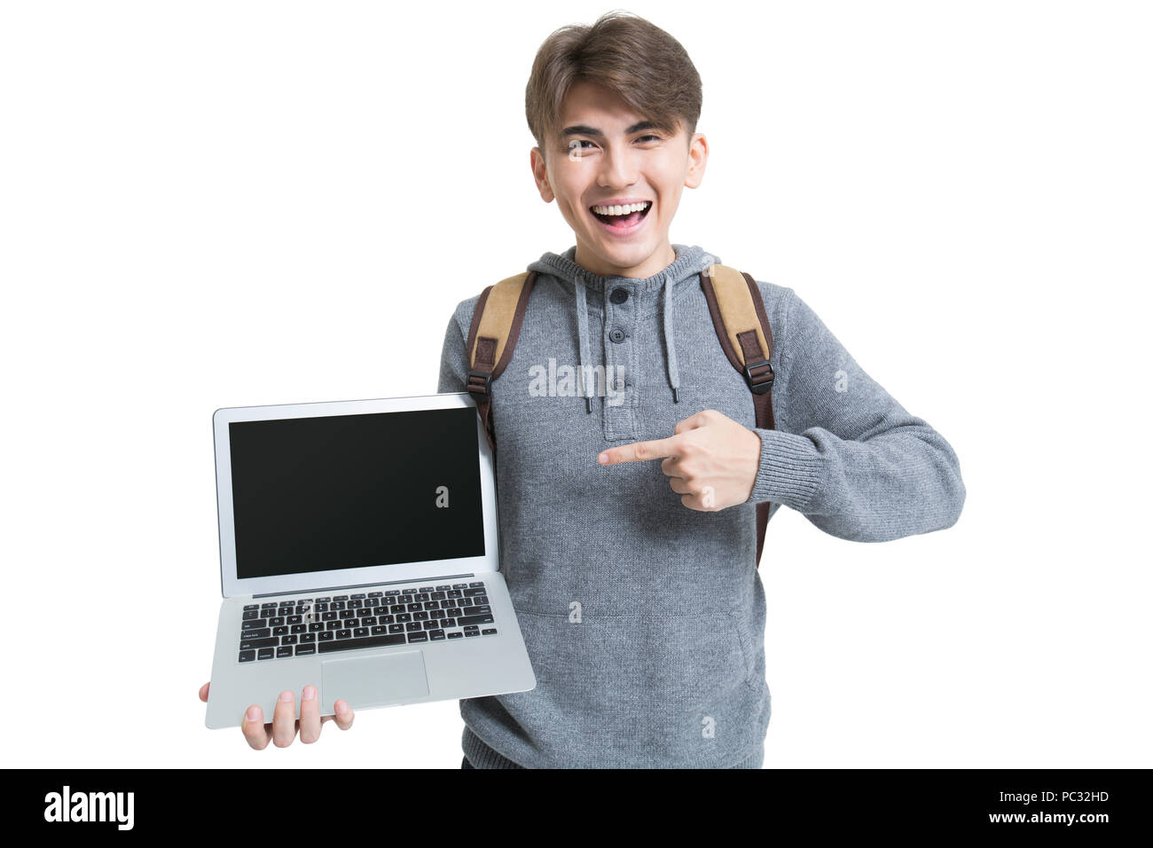 Cheerful male college student showing laptop Stock Photo - Alamy