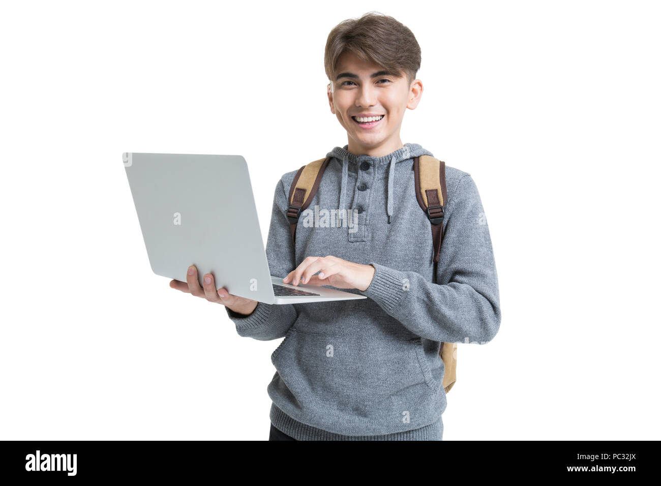 Cheerful male college student using laptop Stock Photo - Alamy