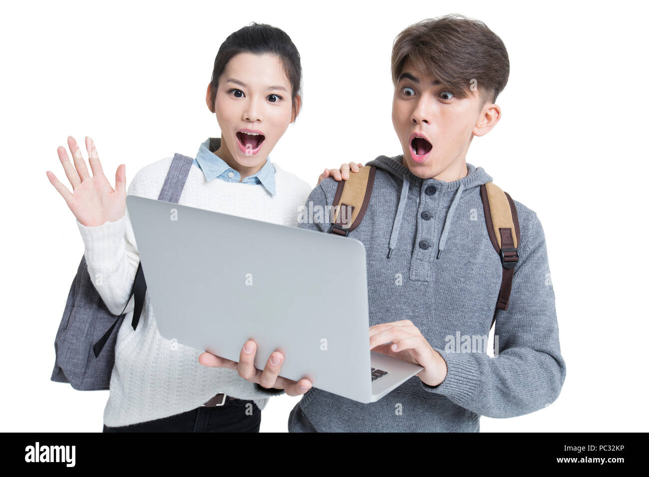 Shocked college students using laptop Stock Photo - Alamy