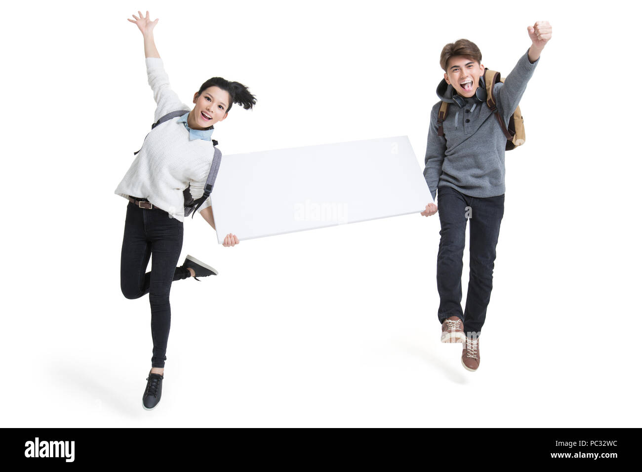 Cheerful college students holding a whiteboard Stock Photo - Alamy