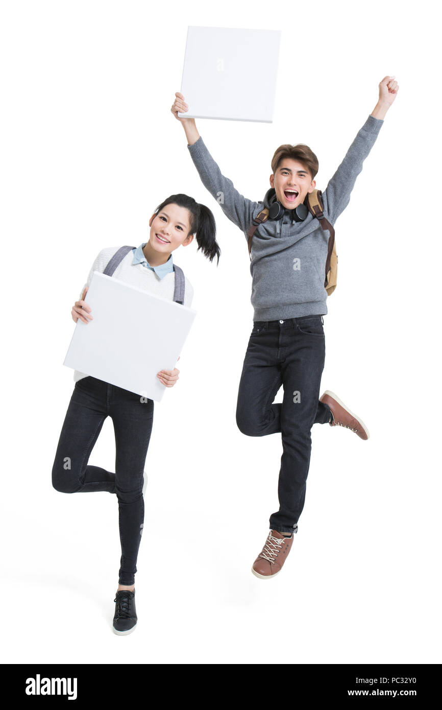 Cheerful college students showing whiteboards Stock Photo - Alamy
