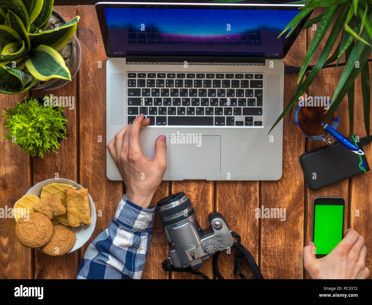 overhead person working at home studio using laptop and smartphone with ...