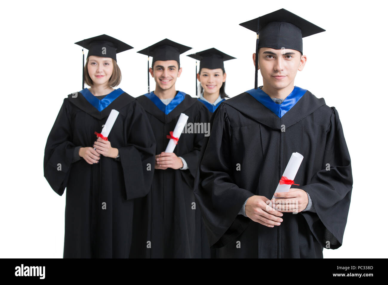 Happy college graduates in graduation gowns Stock Photo - Alamy