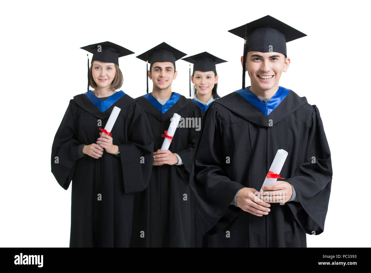 Happy college graduates in graduation gowns Stock Photo - Alamy