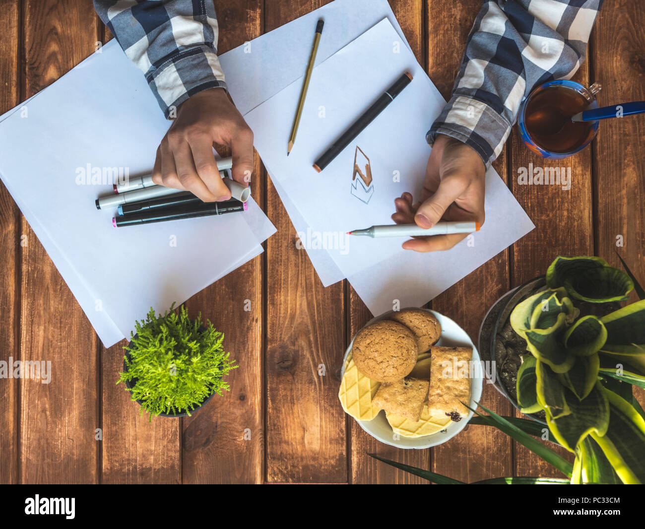overhead view of artist drawing on white blank sheets Stock Photo - Alamy