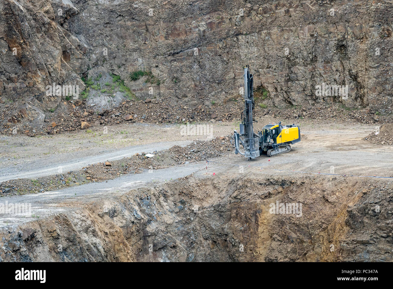 Opencast mining quarry with mining drilling machine. Mining in the ... Opencast mining quarry with mining drilling machine. Mining in the ...