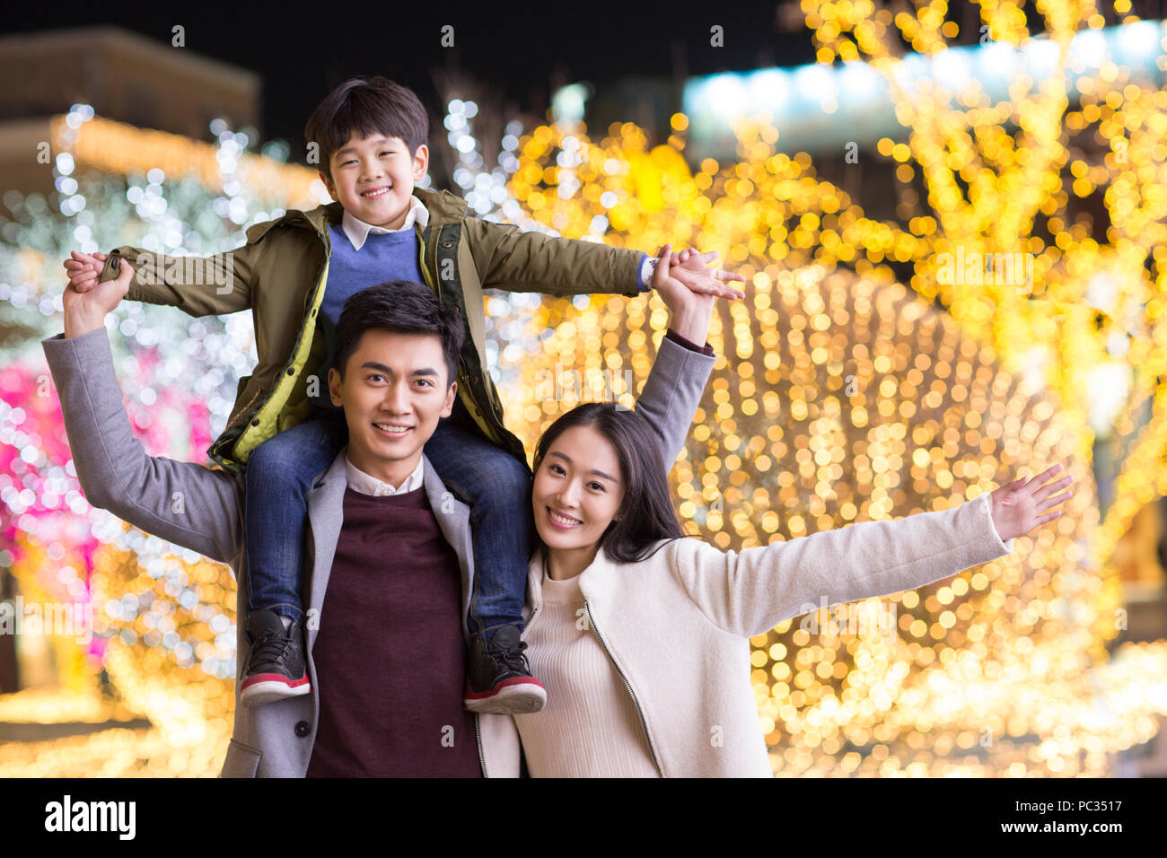 Portrait of cheerful young Chinese family Stock Photo - Alamy