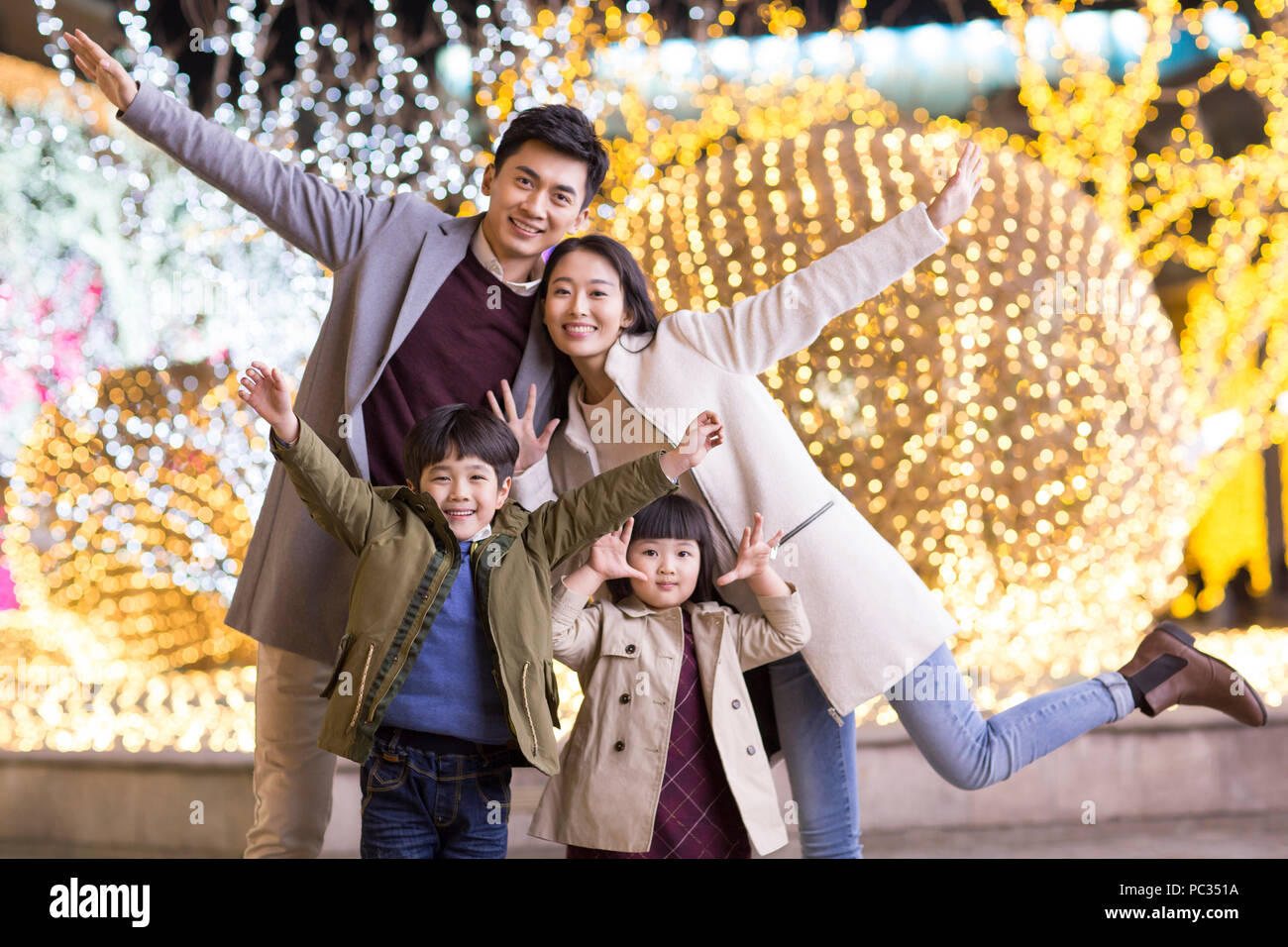 Portrait of cheerful young Chinese family Stock Photo - Alamy