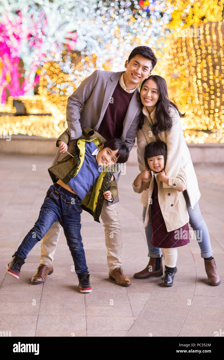 Portrait of cheerful young Chinese family Stock Photo - Alamy