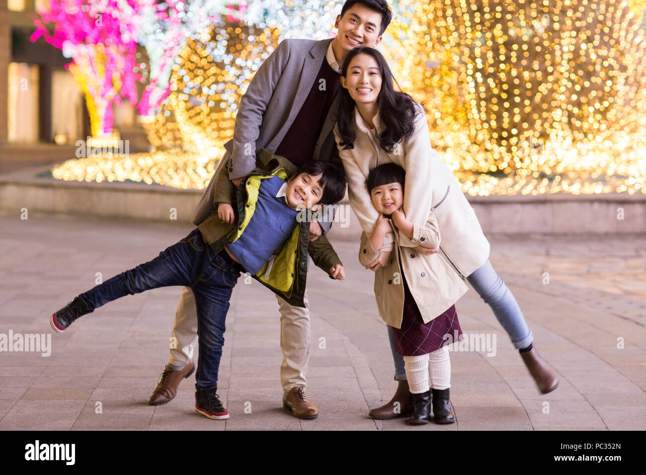 Portrait of cheerful young Chinese family Stock Photo - Alamy