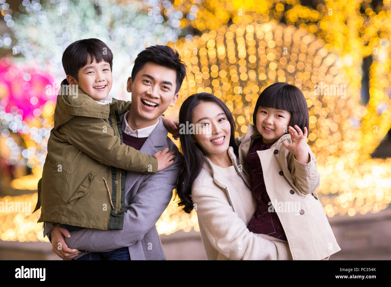 Portrait of cheerful young Chinese family Stock Photo - Alamy