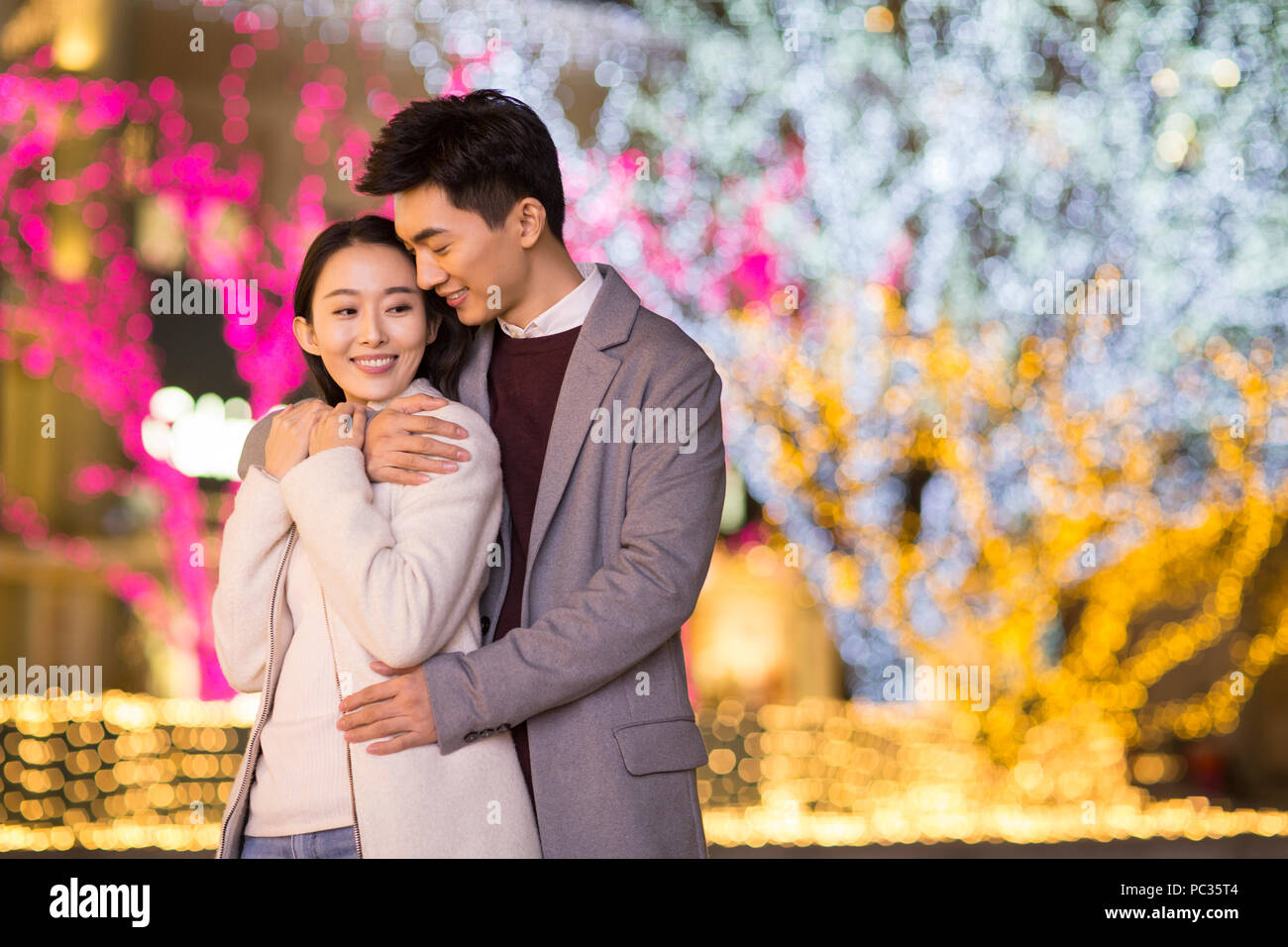 Cheerful young Chinese couple dating Stock Photo - Alamy