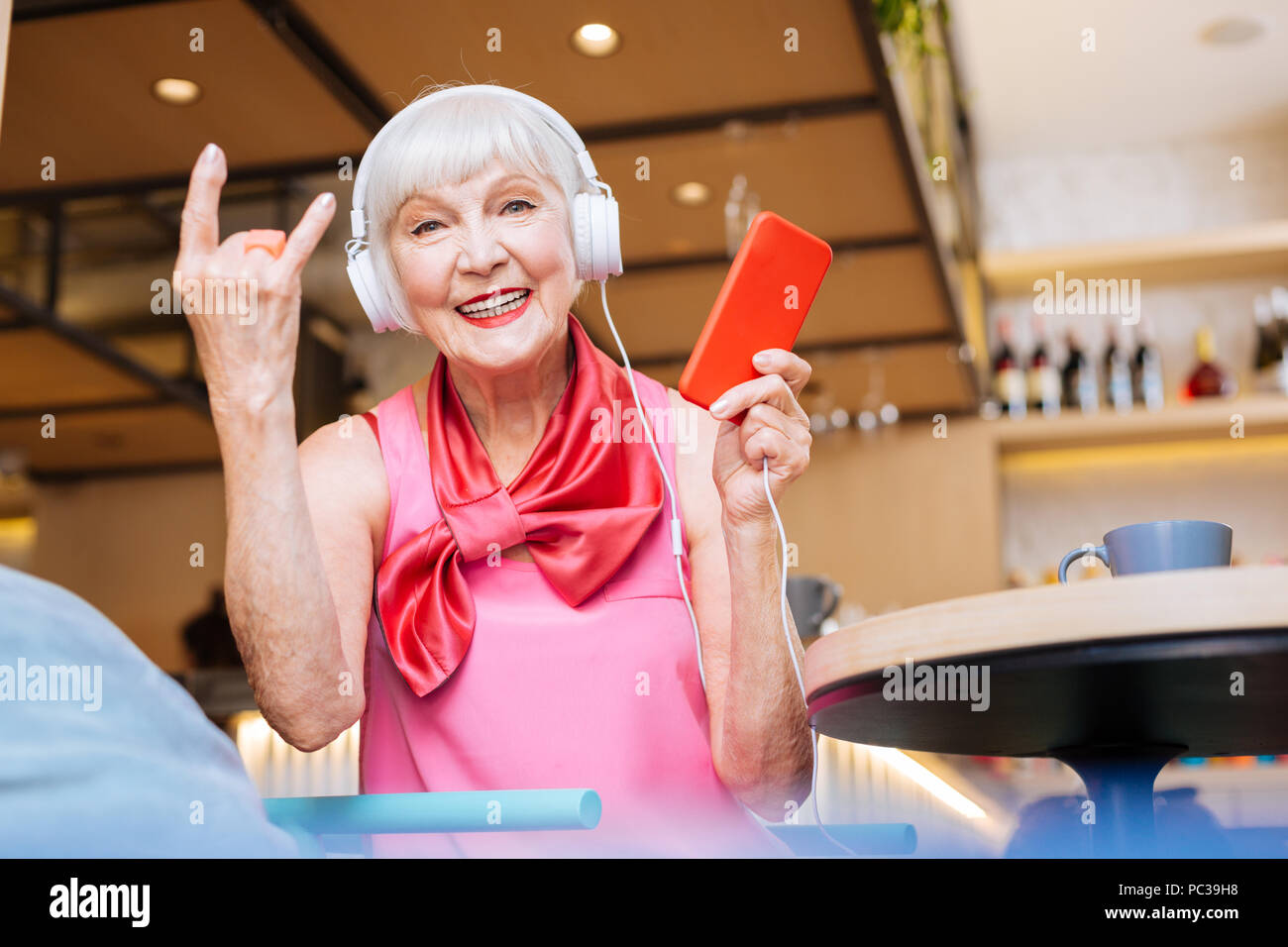 Pleasurable time. Positive nice woman listening to rock music while ...