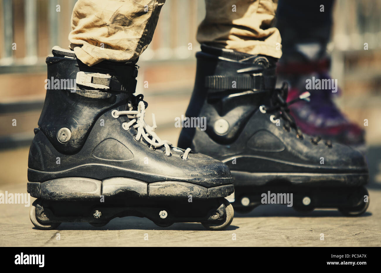 Young aggressive inline roller blader wearing modern skates for extreme ...