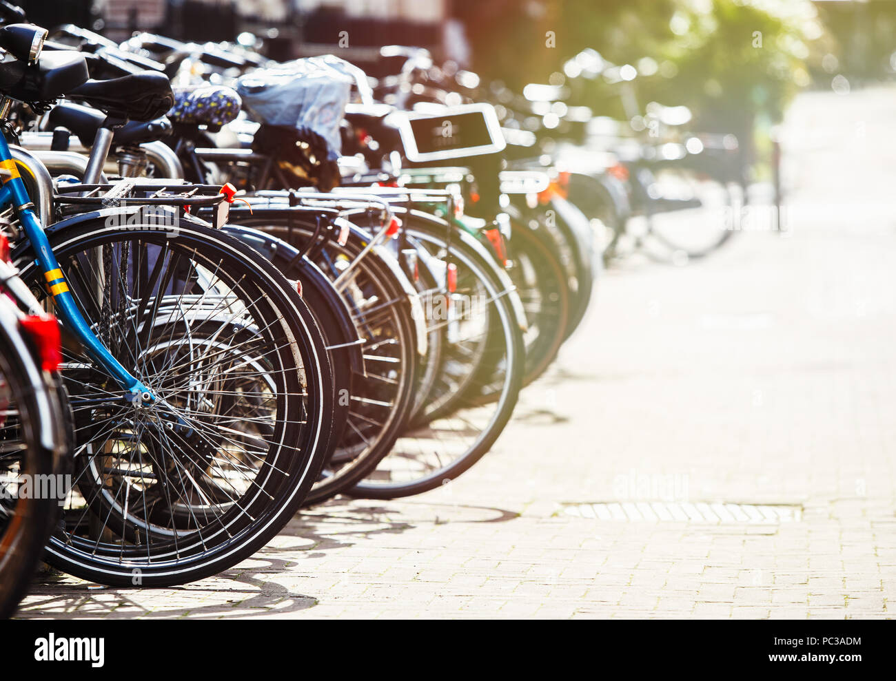 Parking lot with bicycles in the sunny street of big city. Many ...