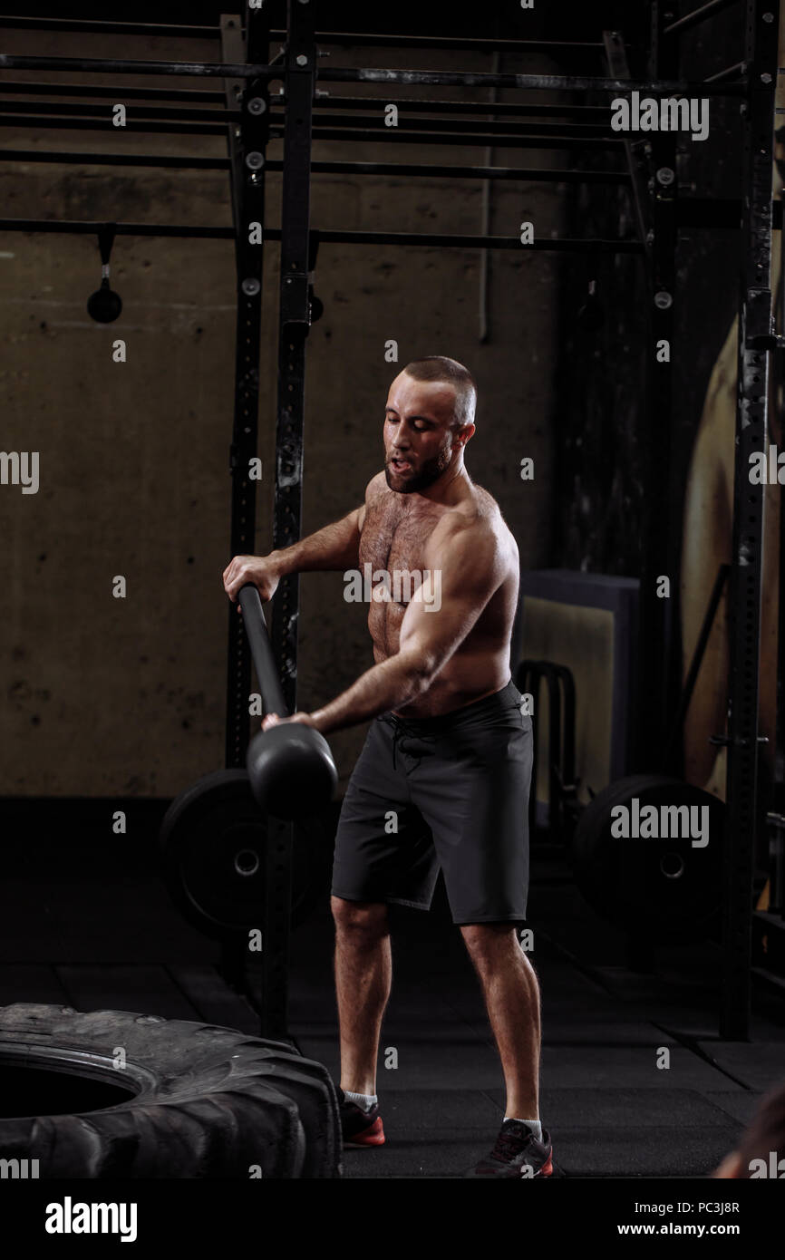 handsome talented bodybuilder with open mouth is swinging down the ...