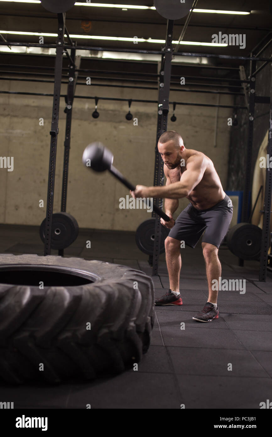 hammer strength. sporty man controlling the bounce of the hammer. full ...