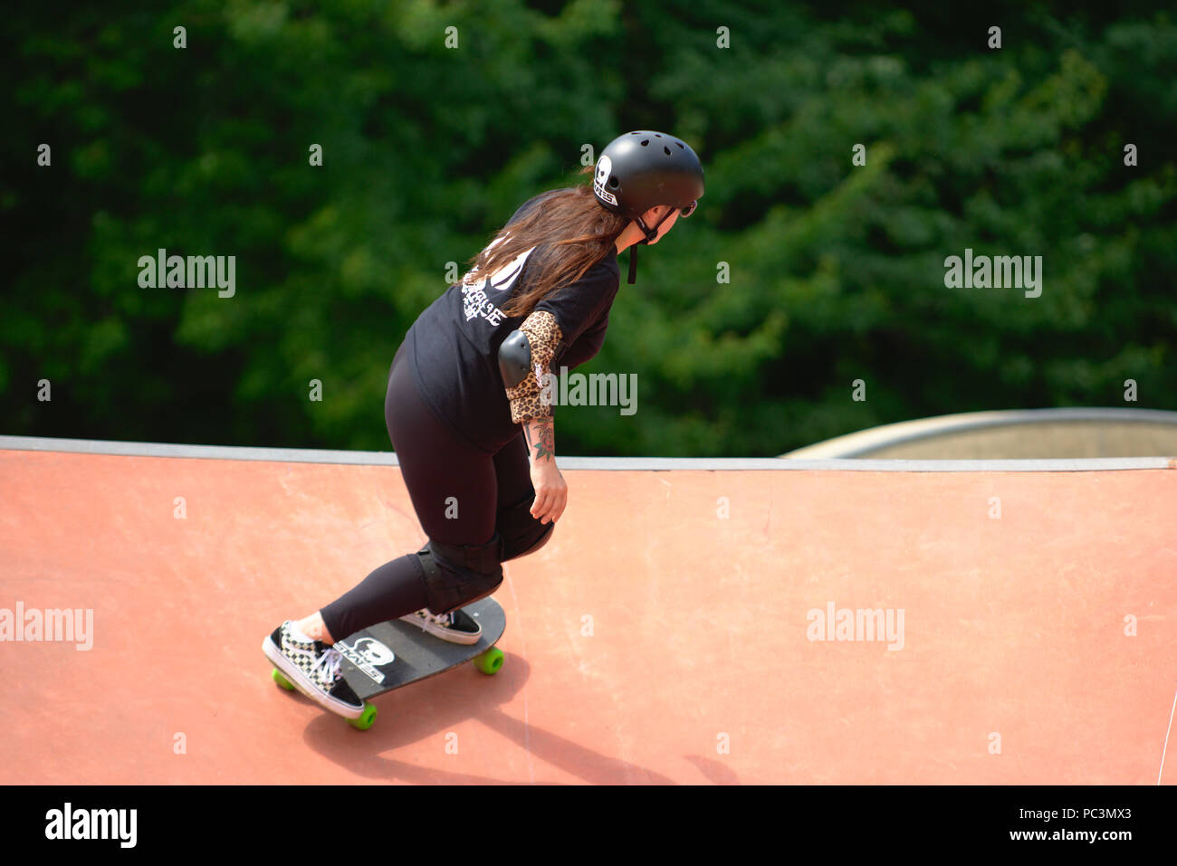 Adult female skateboarding at park Stock Photo - Alamy