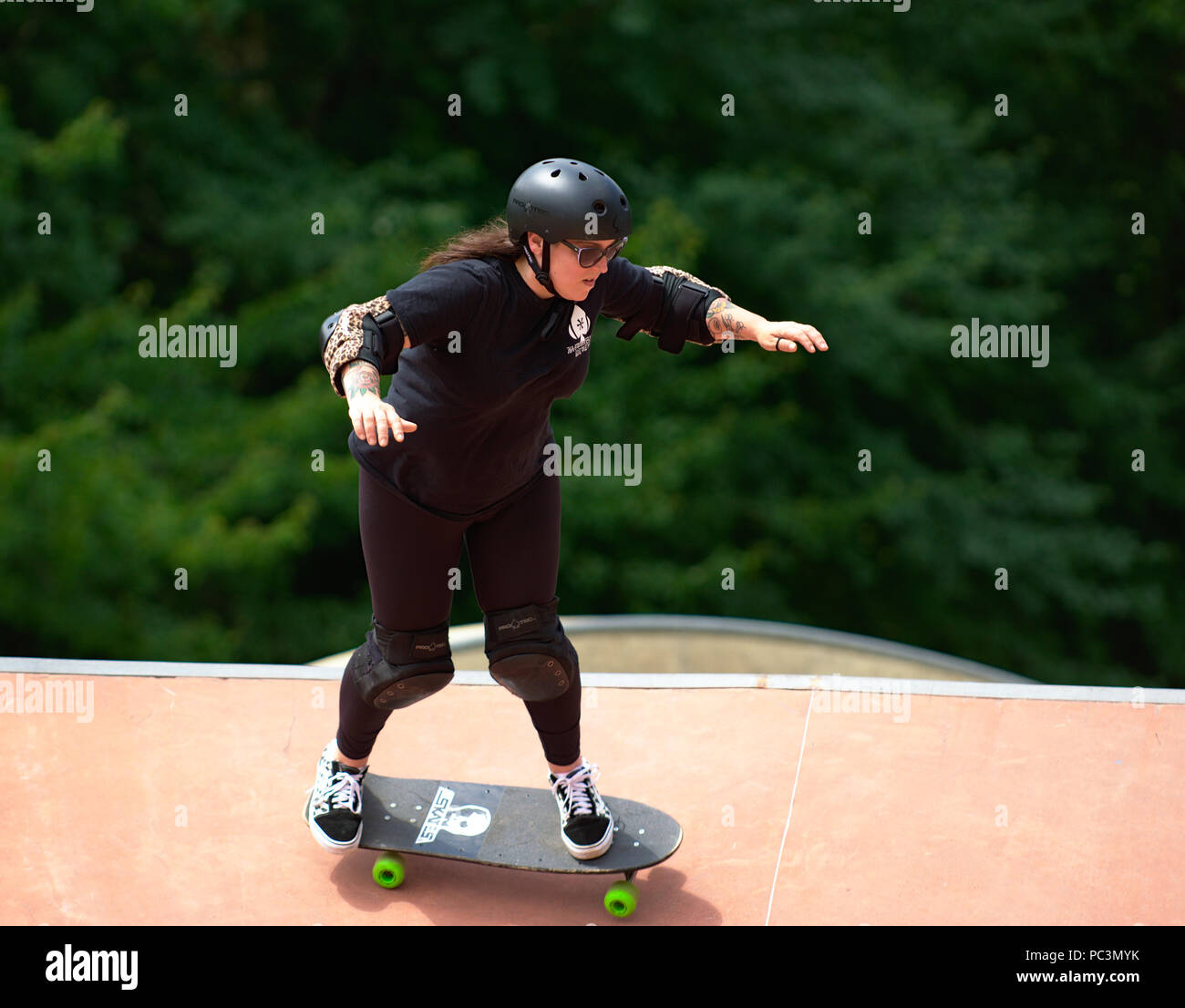 Adult female skateboarding at park Stock Photo - Alamy