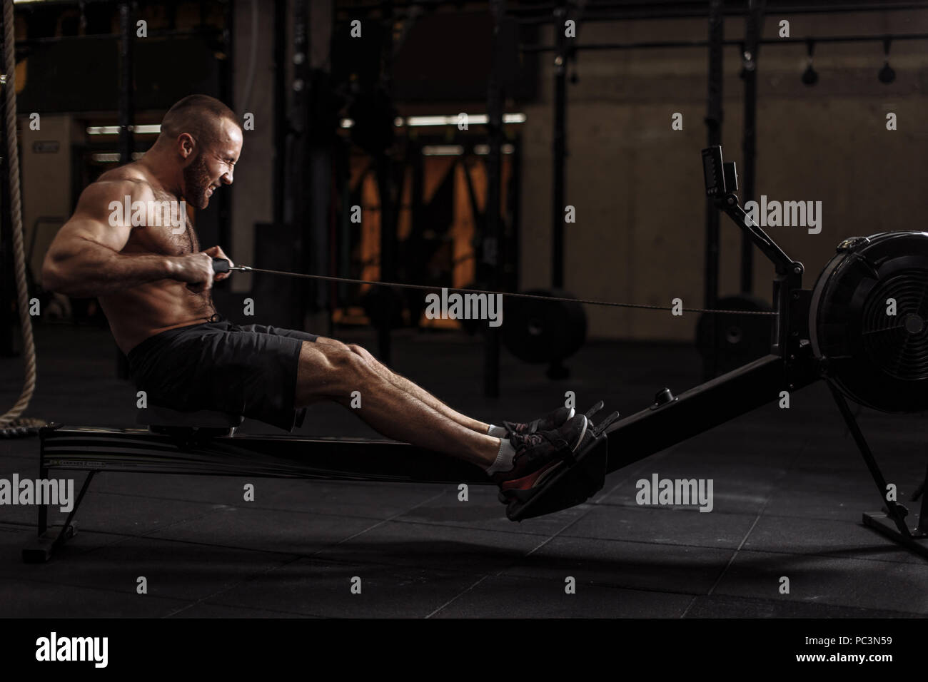 difficult workout in the sport center.athlete with closed eyes doing ...