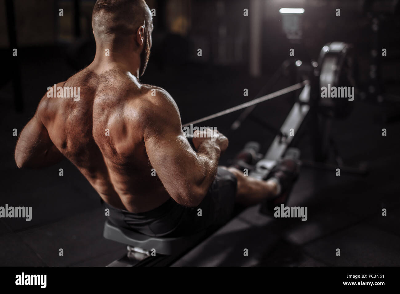 close up back view photo. shirtless male using training simulation in ...
