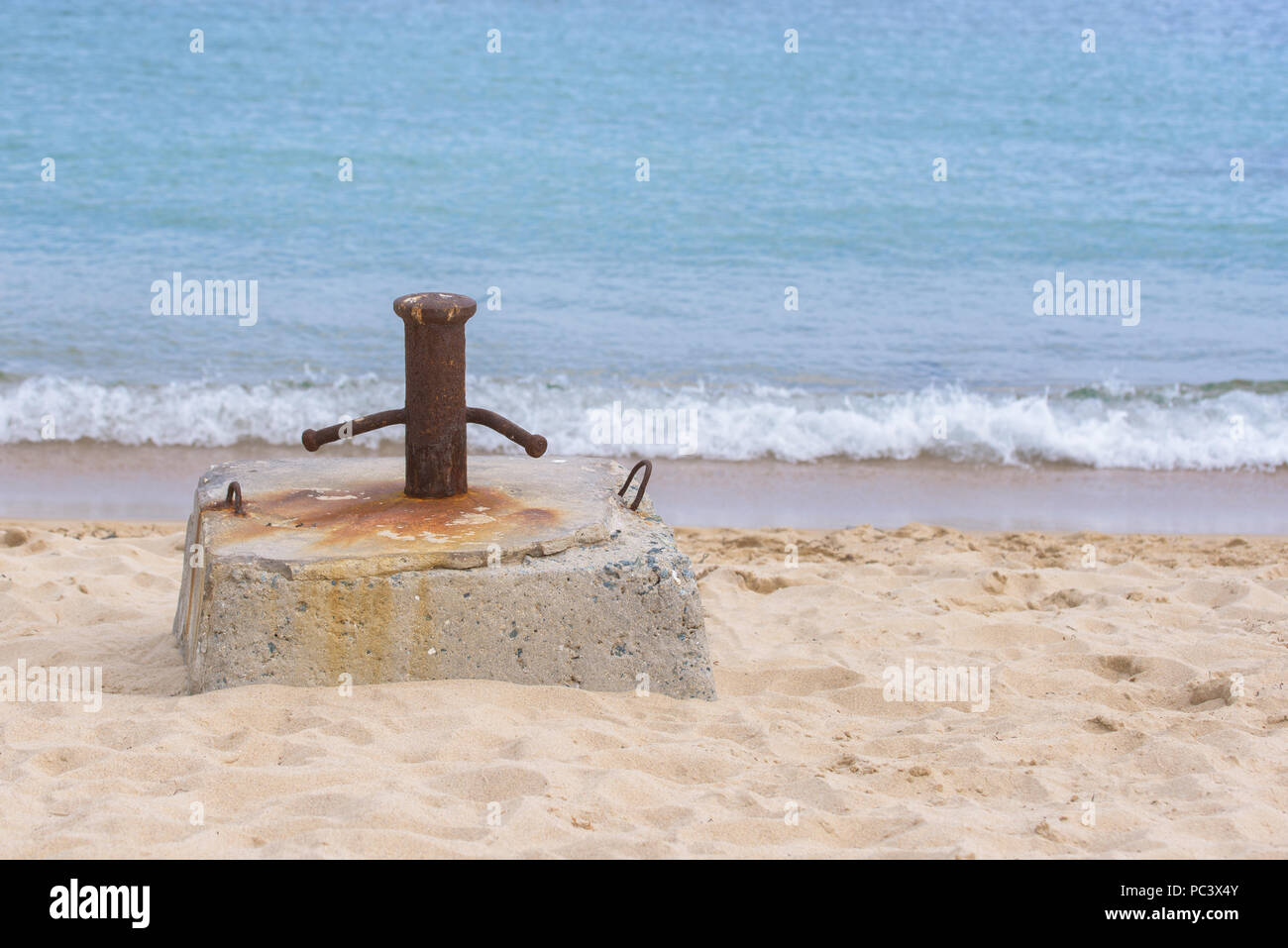 Bollard on the beach. Mooring bollard on sea water background Stock ...