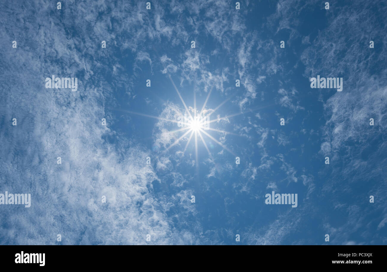 Sun shining through unusual clouds Stock Photo - Alamy