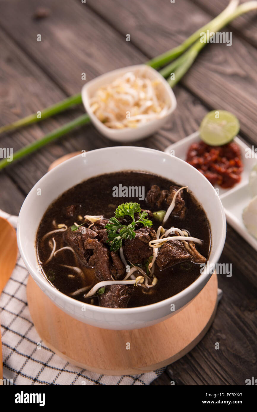 Rawon. traditional Indonesian beef black soup Stock Photo - Alamy