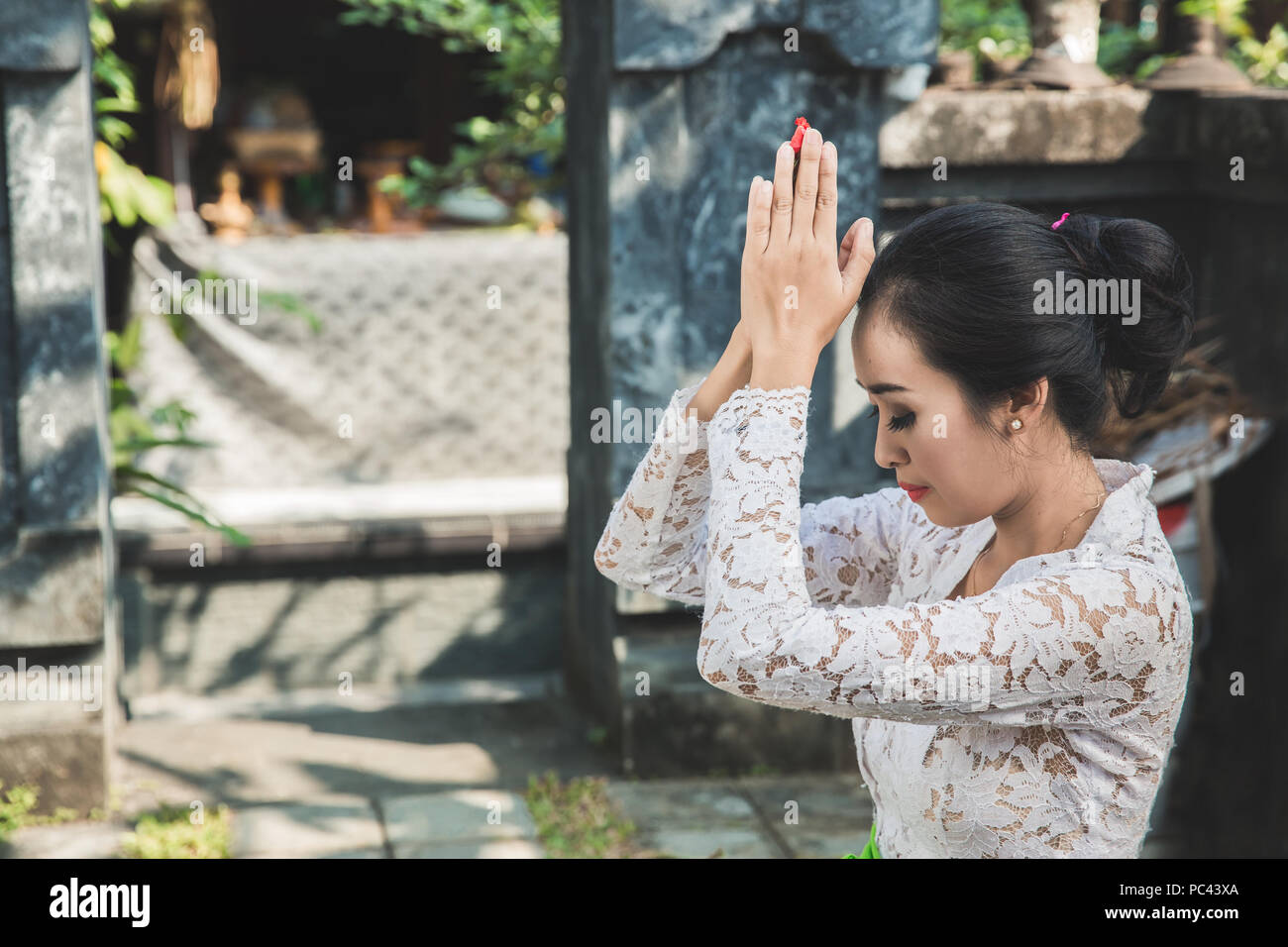 balinese woman praying at temple on small shrines in houses Stock Photo ...