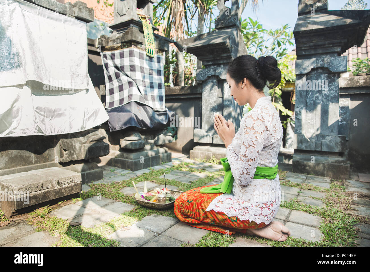balinese woman praying at temple on small shrines in houses Stock Photo ...
