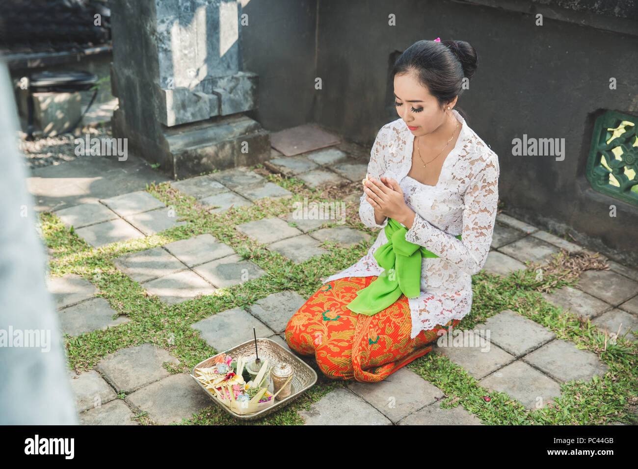 balinese woman praying at temple on small shrines in houses Stock Photo ...