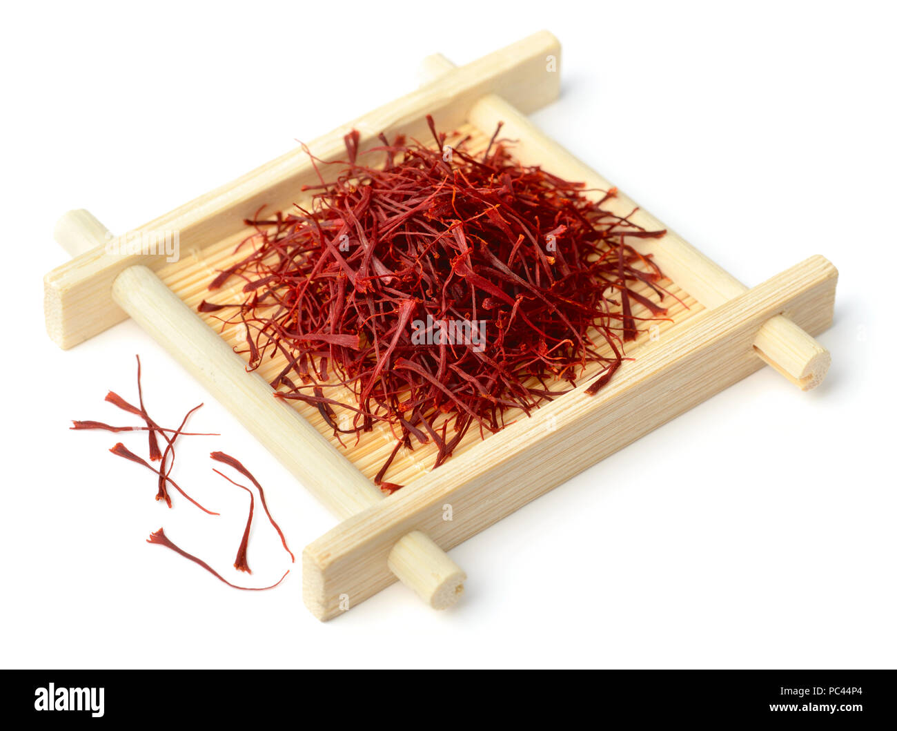 saffron thread in the wooden plate, isolated on white background Stock ...