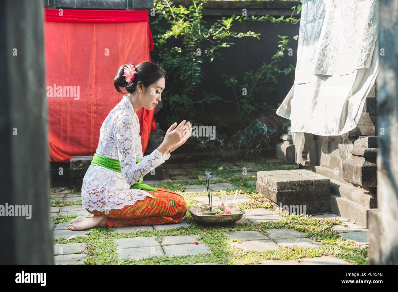 balinese woman praying at temple on small shrines in houses Stock Photo ...