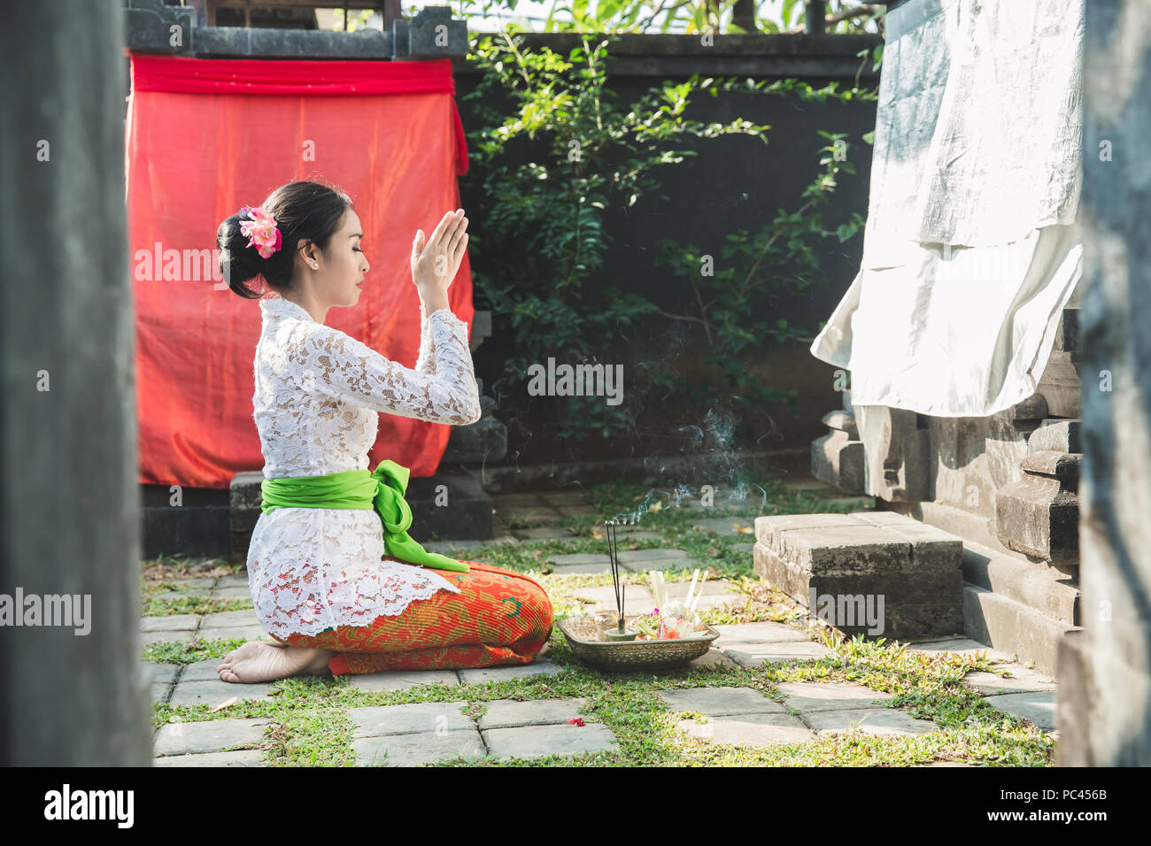 balinese woman praying at temple on small shrines in houses Stock Photo ...