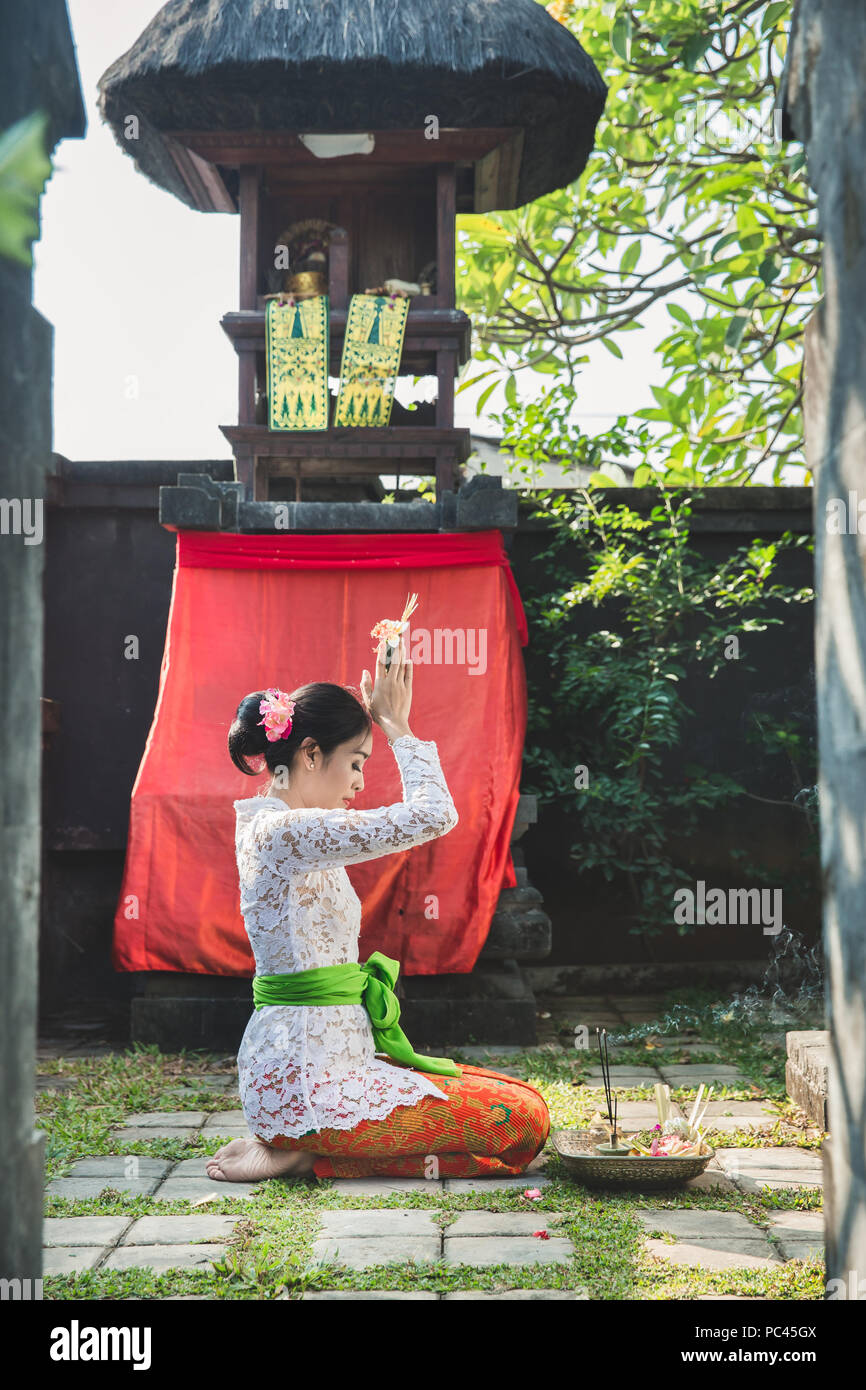 balinese woman praying at temple on small shrines in houses Stock Photo ...