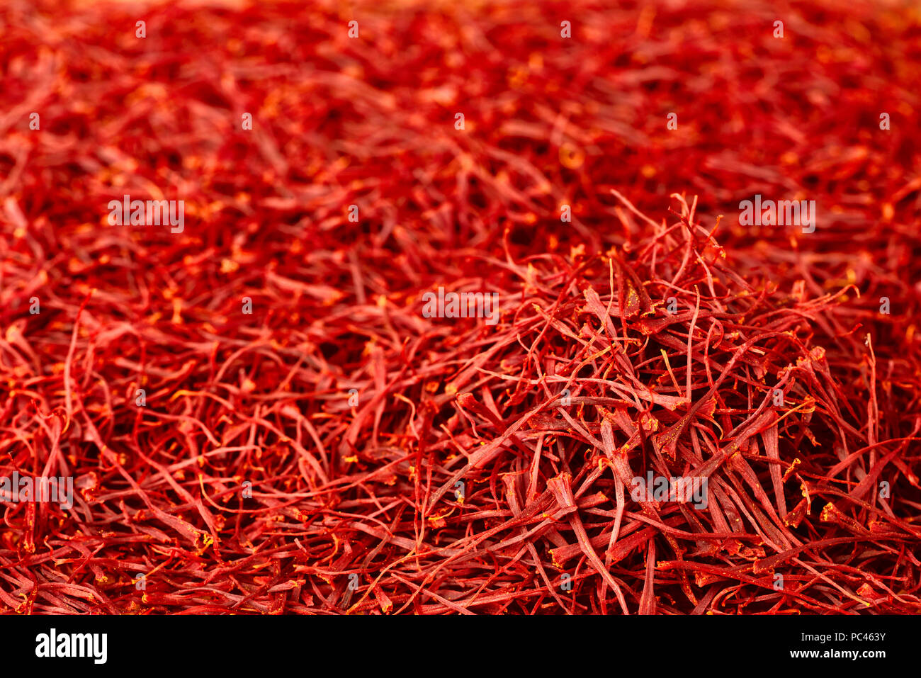 food background of red dried saffron thread spice Stock Photo - Alamy