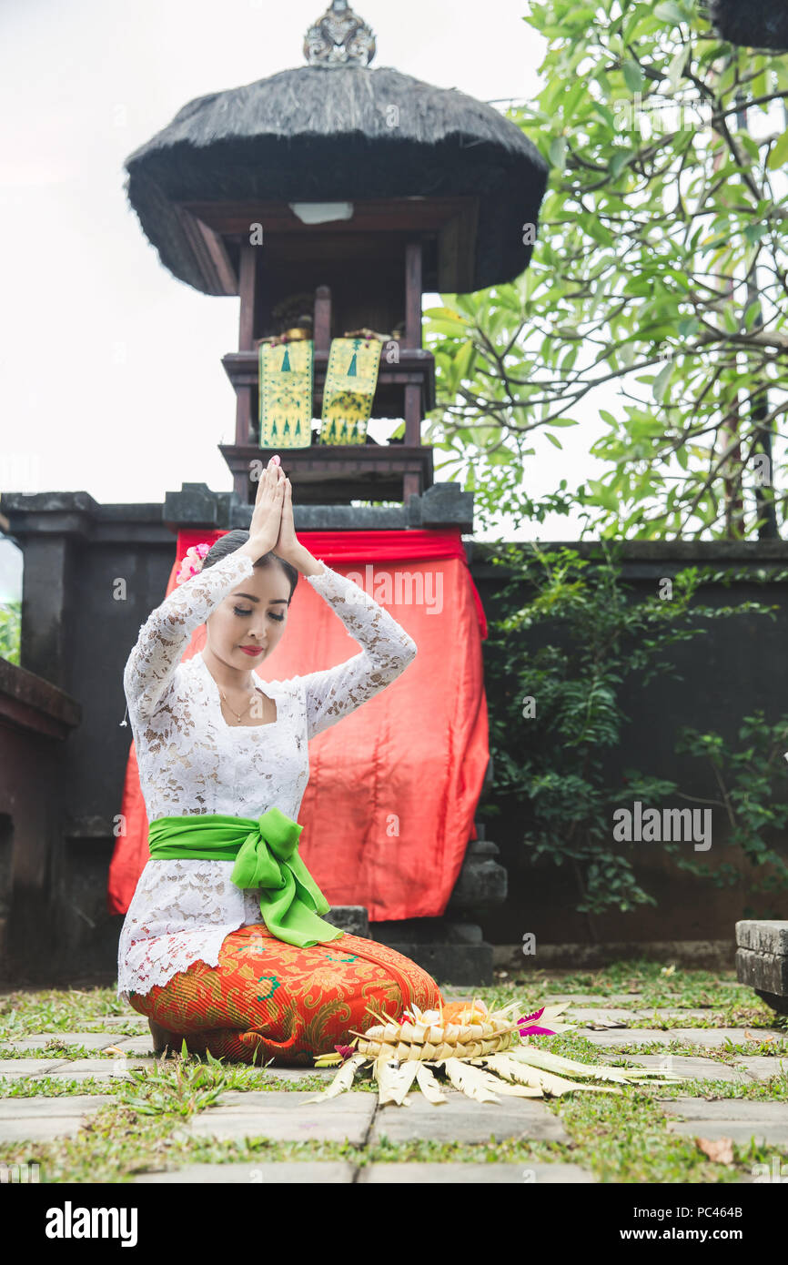 balinese woman praying at temple on small shrines in houses Stock Photo ...