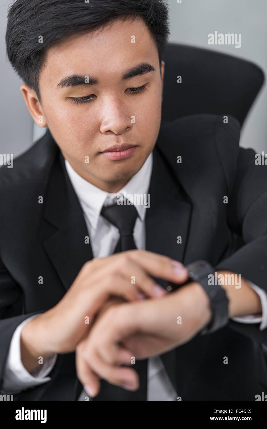 young business man checking time on smart watch Stock Photo - Alamy