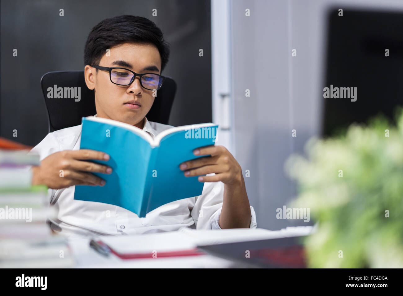 young student reading a book Stock Photo - Alamy