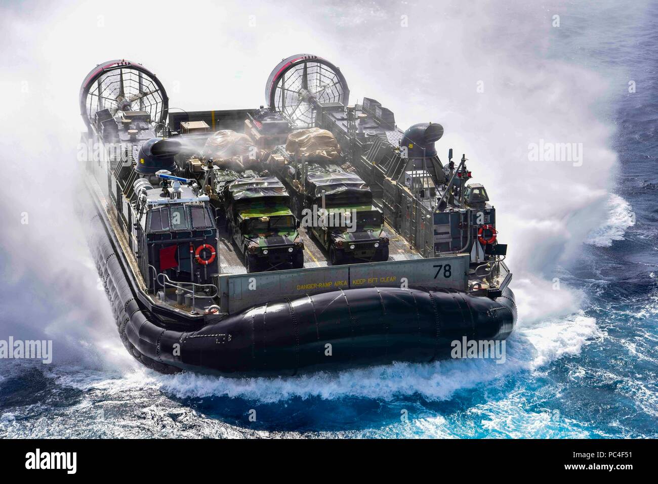 A U.S. Navy landing craft air cushion (LCAC), attached to Assault Craft ...