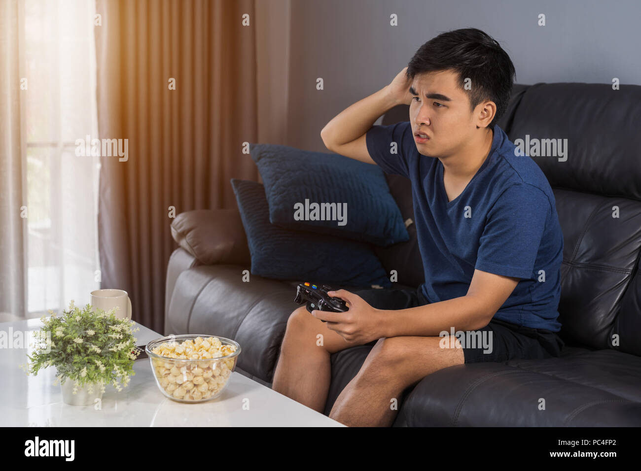 sad young man playing video games and loses Stock Photo - Alamy