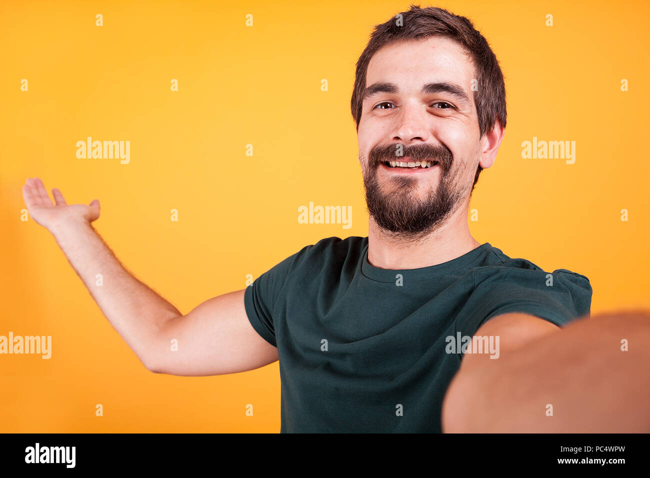 Cool smiling handsome guy smiling at the camera while taking a selfie ...