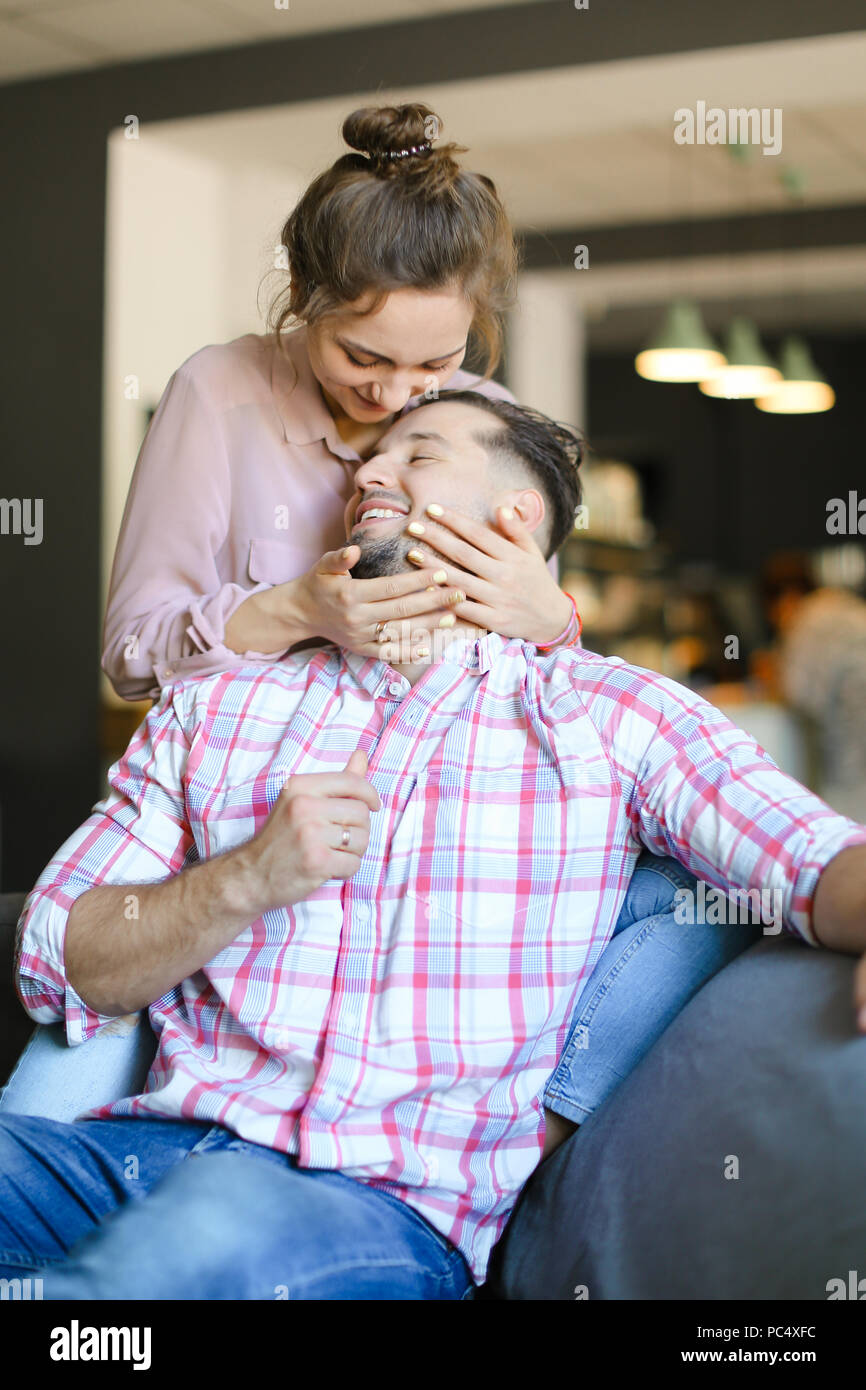 Young european wife kissing husband at home Stock Photo - Alamy