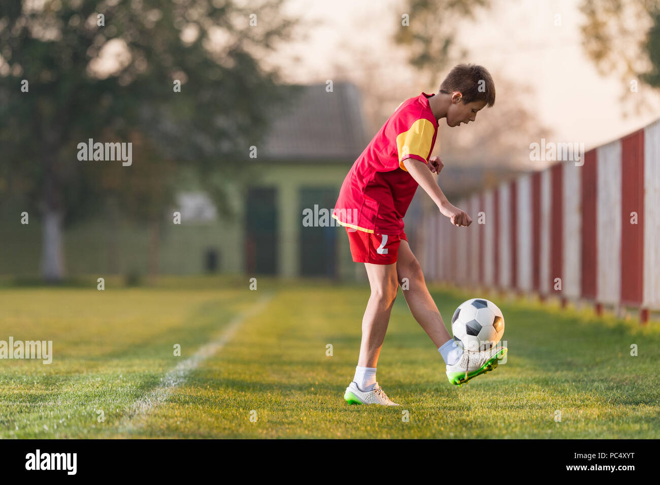 Child playing football on a soccer field Stock Photo - Alamy