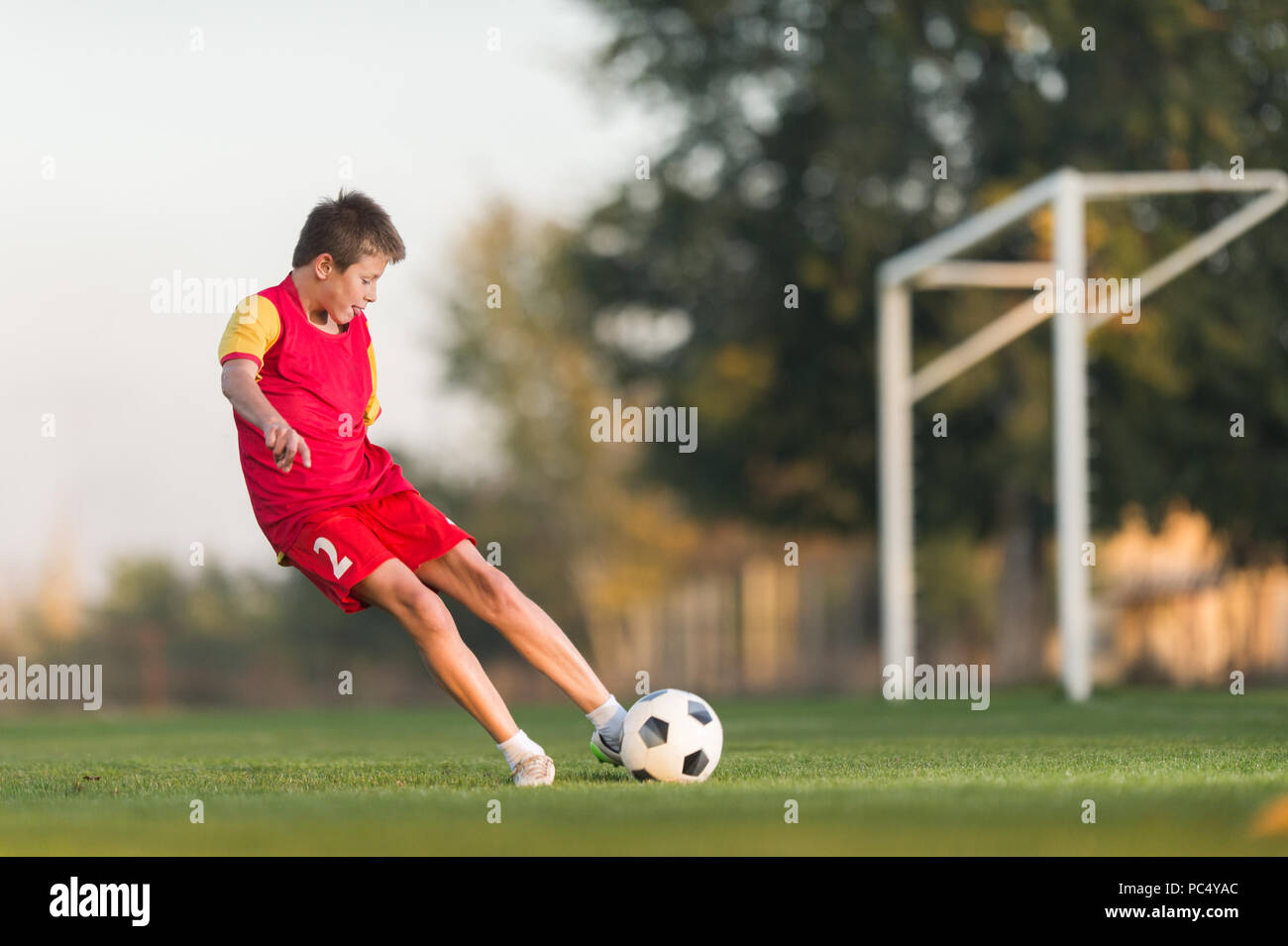 Boy boys kicking a ball hi-res stock photography and images - Alamy
