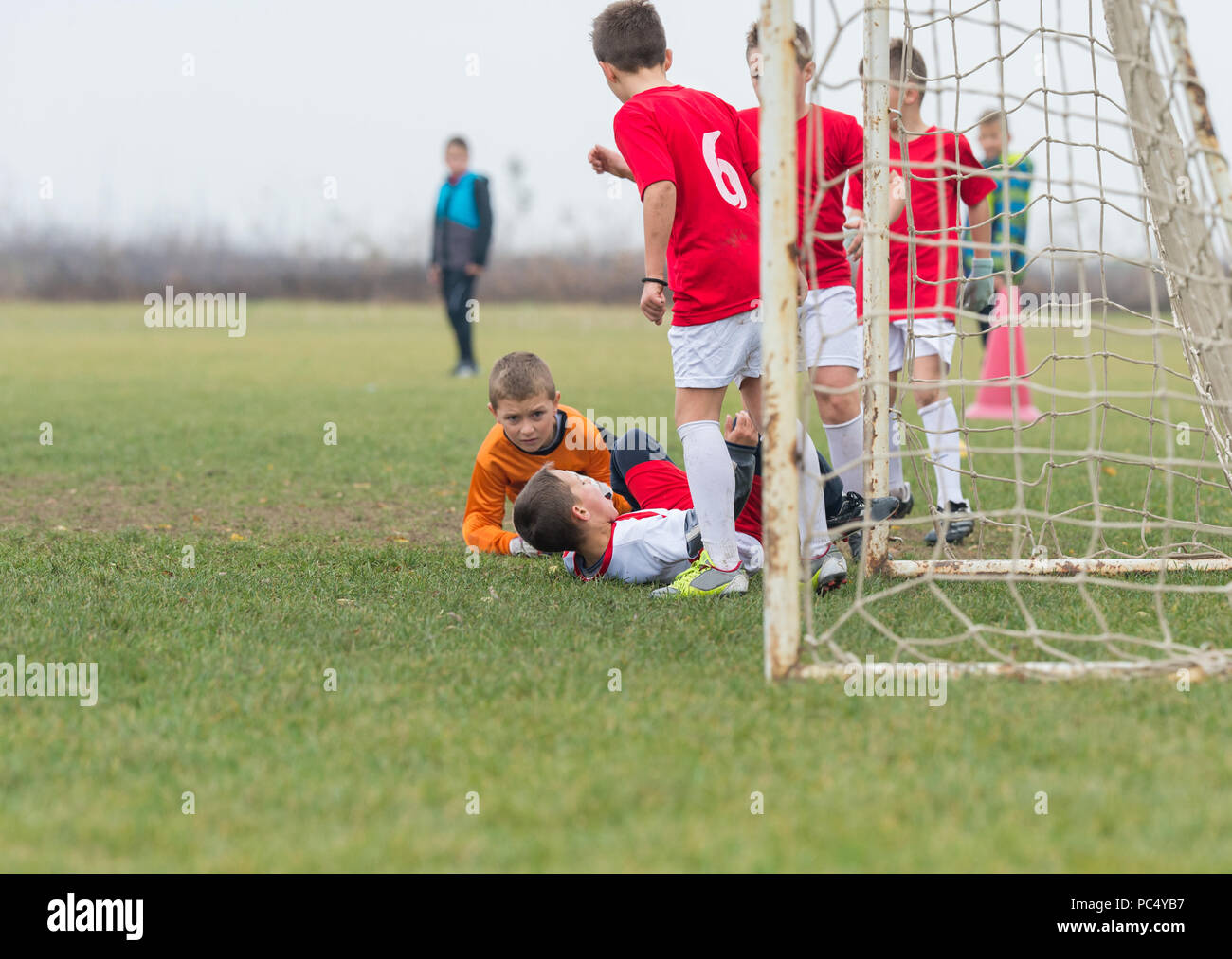 boys kicking football on the sports field Stock Photo - Alamy