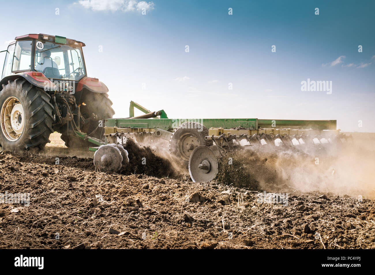 Tractor preparing land for sowing Stock Photo - Alamy